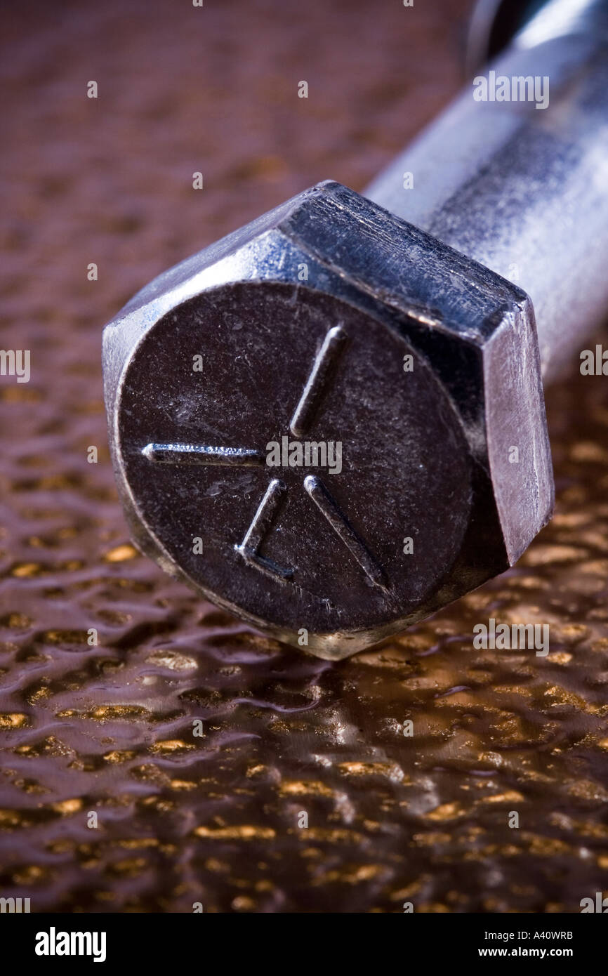 End of steel bolt against beaten copper background Stock Photo - Alamy