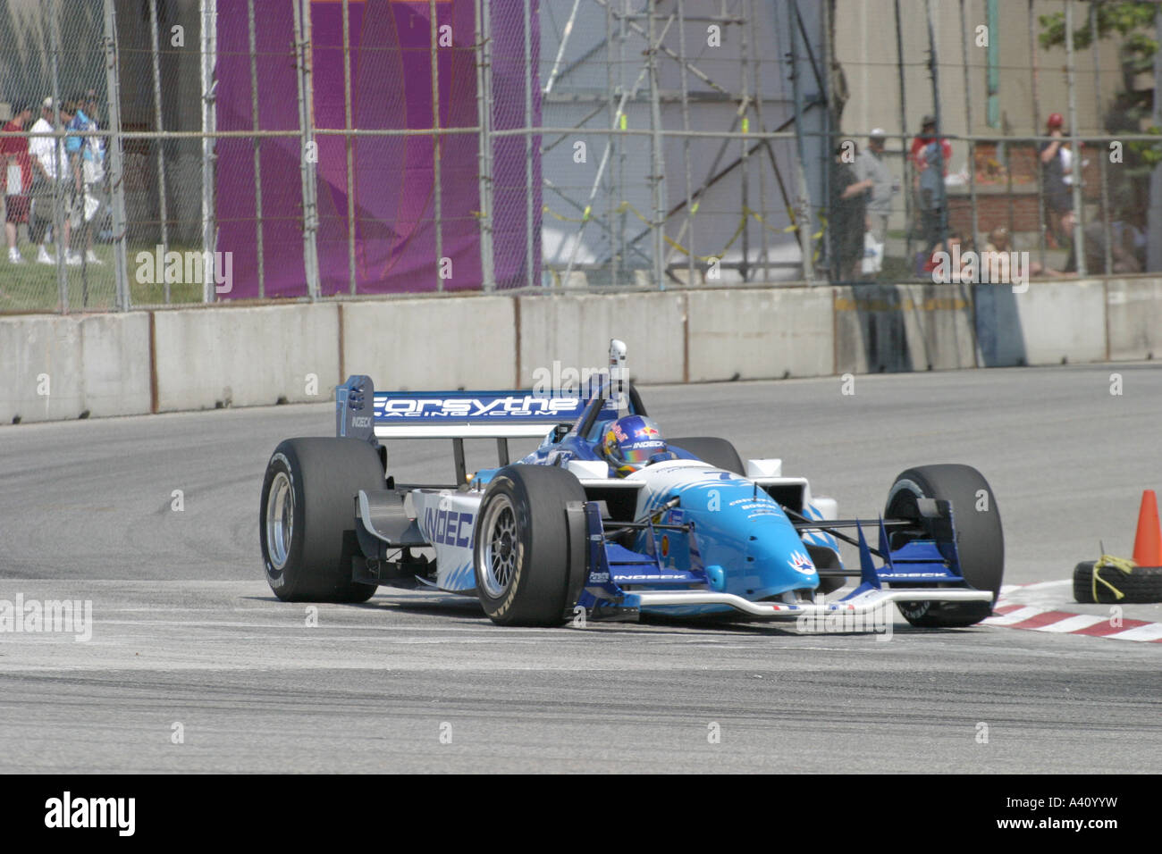 blue race car speeding around corner during race Stock Photo - Alamy