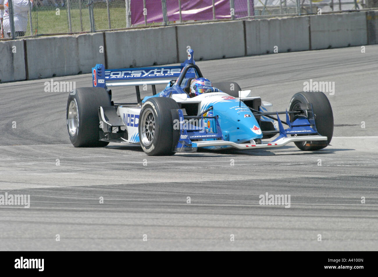 blue race car speeding around curve during race Stock Photo - Alamy