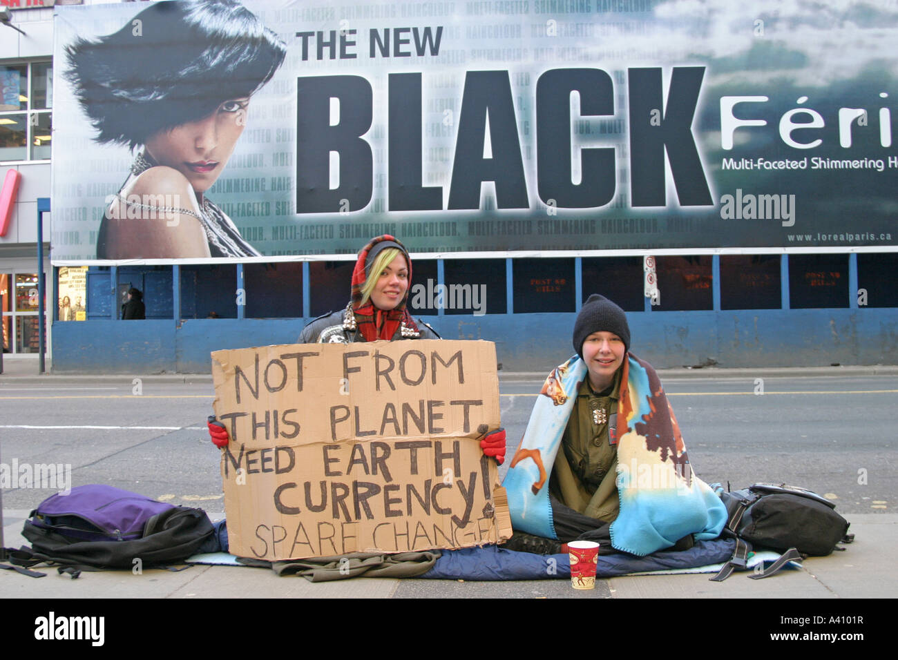 street panhandlers with humourous sign Stock Photo - Alamy