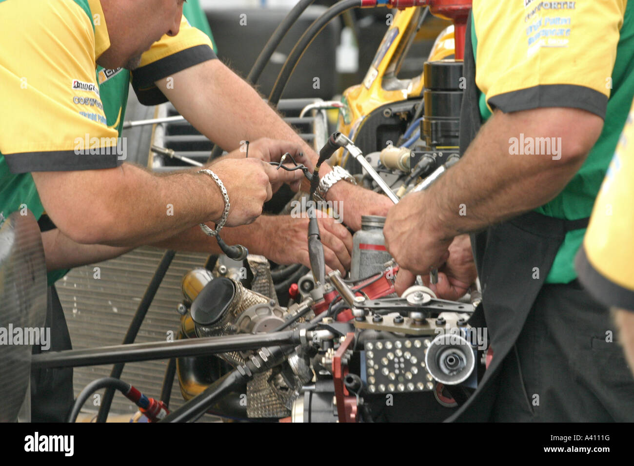 mechanic's hands working on racing car engine Stock Photo - Alamy
