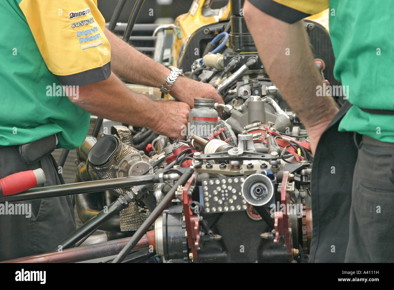 mechanic's hands working on racing car engine Stock Photo - Alamy