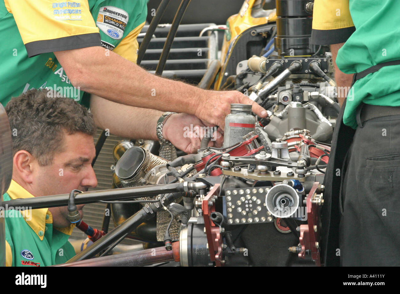 mechanics concentrating on adjusting racing car engine Stock Photo - Alamy