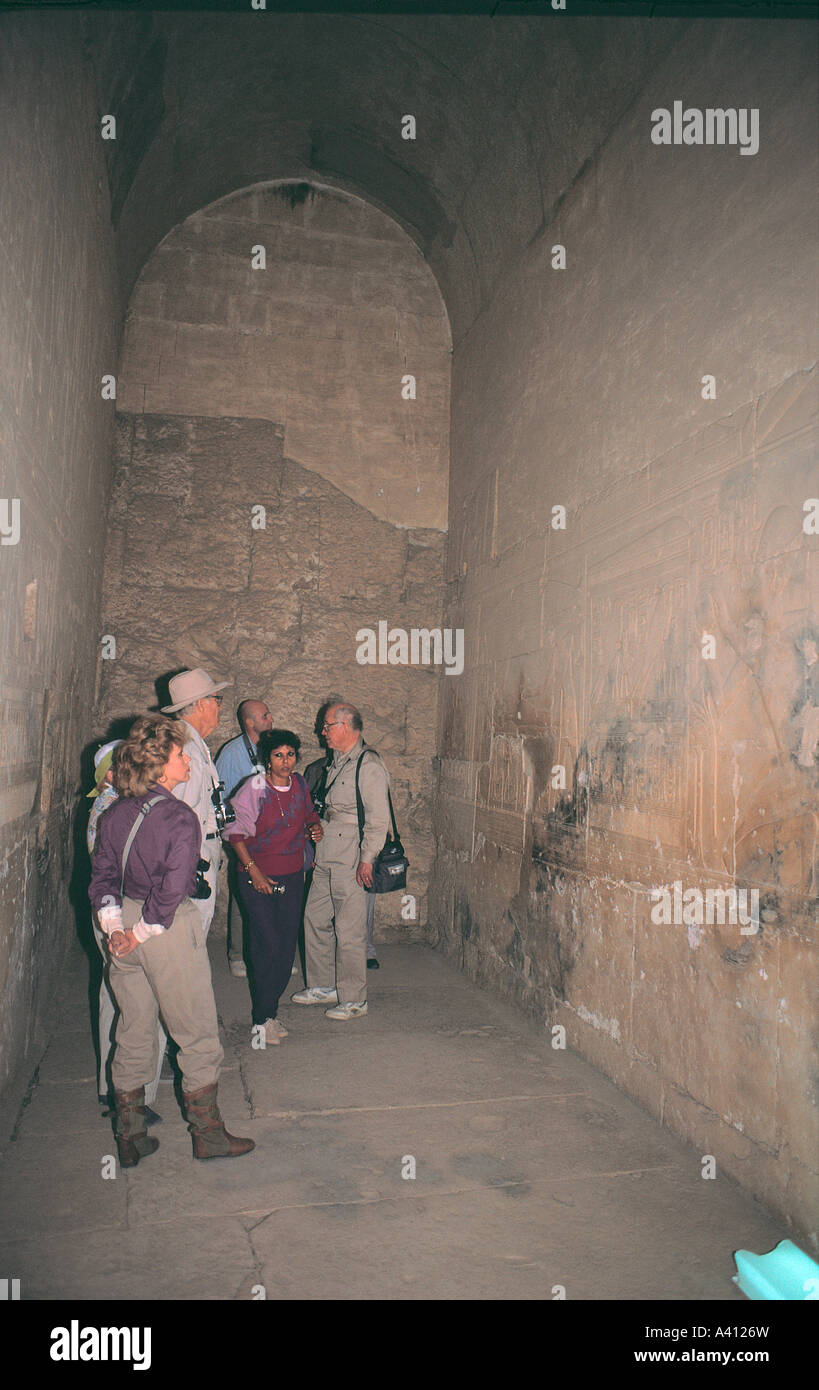 Tourists with their Egyptologist Guide inside the interior of the ...