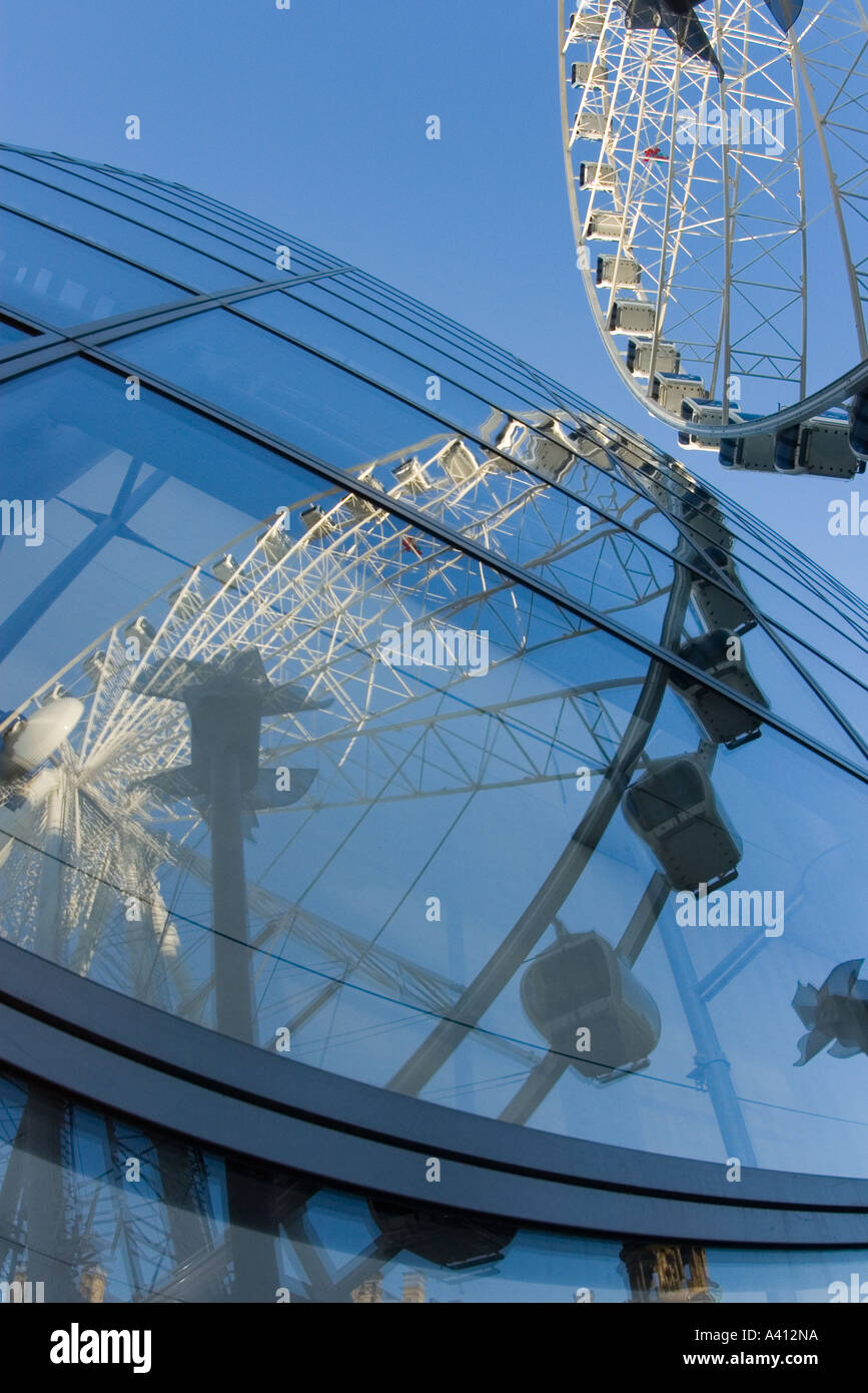 Distorted reflection of the Manchester Wheel in the glass windows of ...