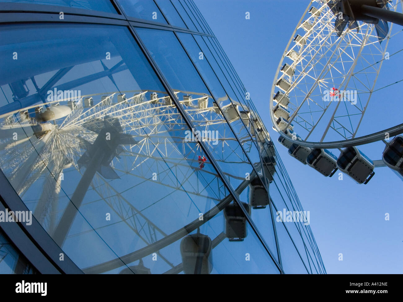 Distorted reflection of the Manchester Wheel in the glass windows of ...