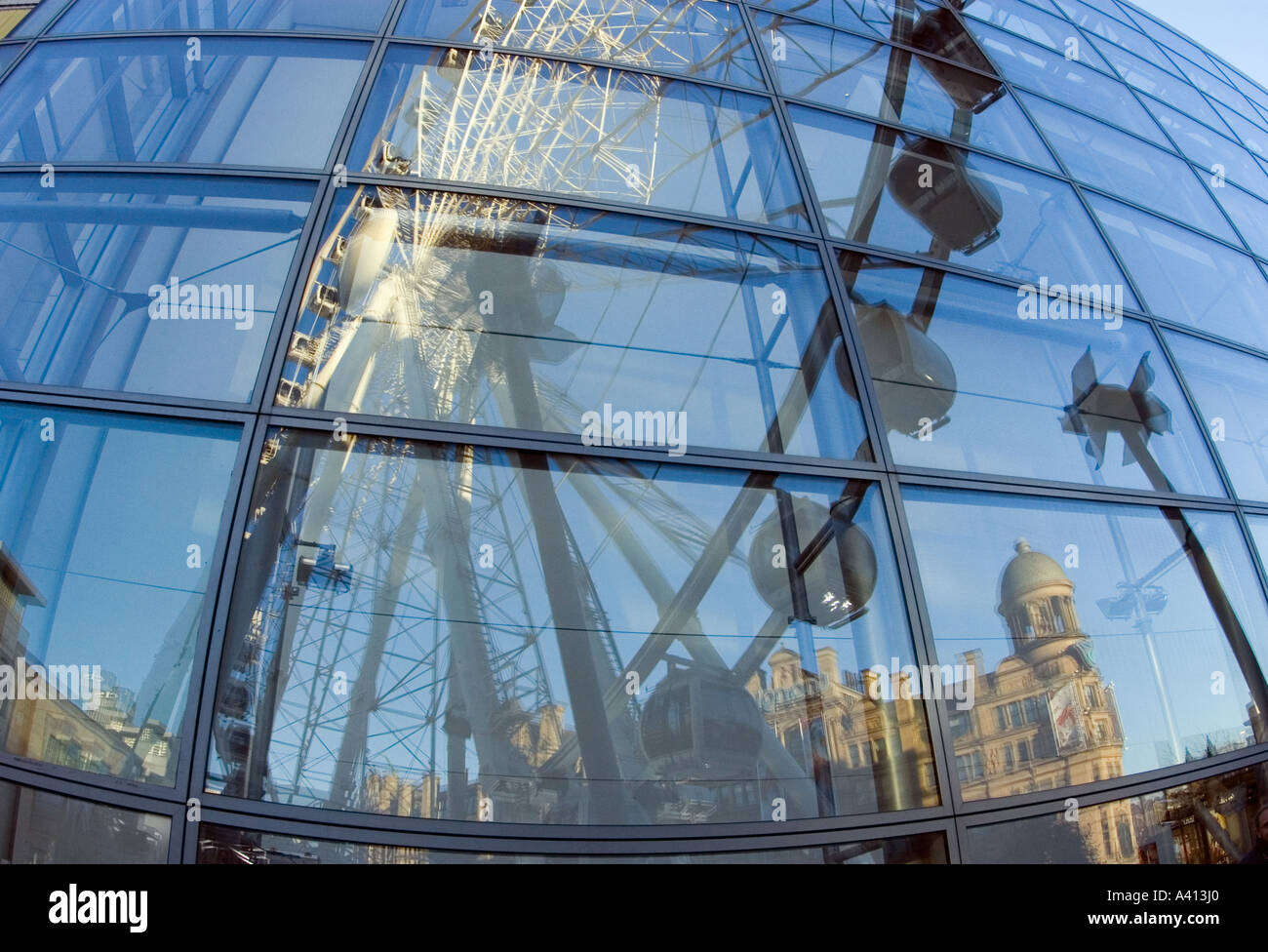 Distorted reflection of the Manchester Wheel in the glass windows of ...