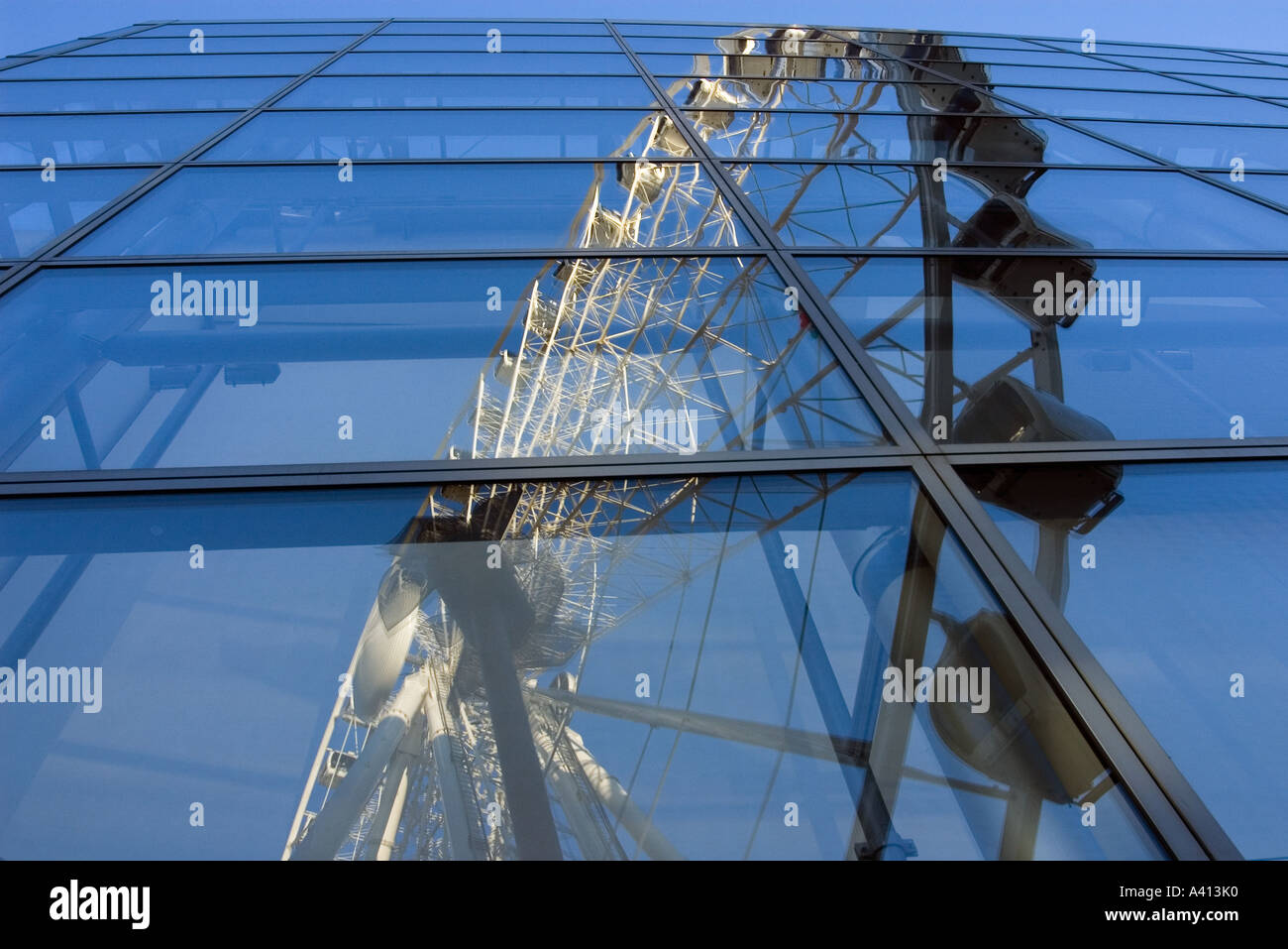 Distorted reflection of the Manchester Wheel in the glass windows of ...