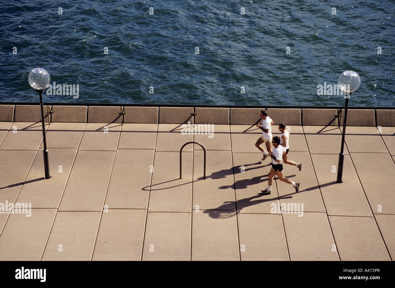 Joggers running on waterfront promenade Sydney Australia Stock Photo ...
