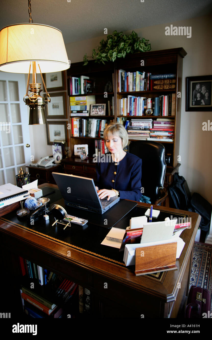 Professional female executive businesswoman sitting at her office desk ...