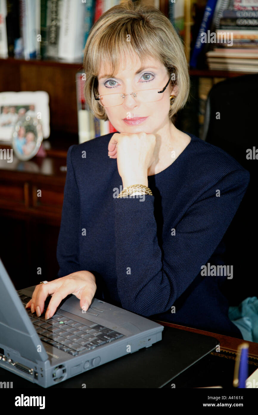 Professional female executive businesswoman sitting at her office desk ...