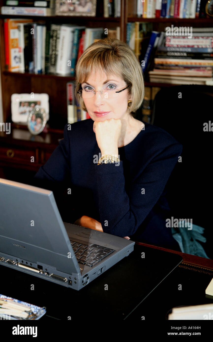 Professional female executive businesswoman sitting at her office desk ...