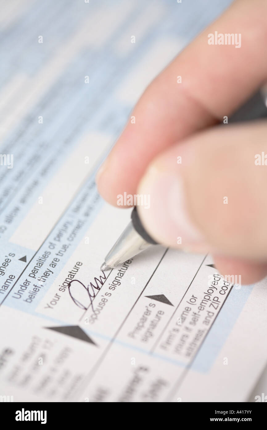 Signing tax form hi-res stock photography and images - Alamy