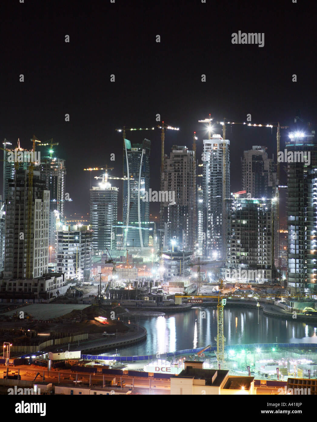 Skyscrapers under construction at night, dubai, UAE. February 2007 ...