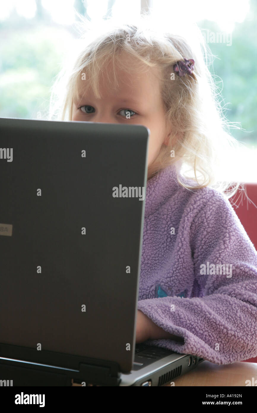 young girl secretly using laptop computer Stock Photo - Alamy