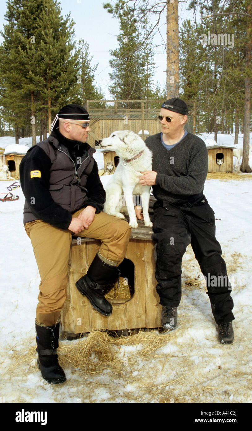 Huskies and their handlers in Swedish Lapland Sweden Stock Photo - Alamy