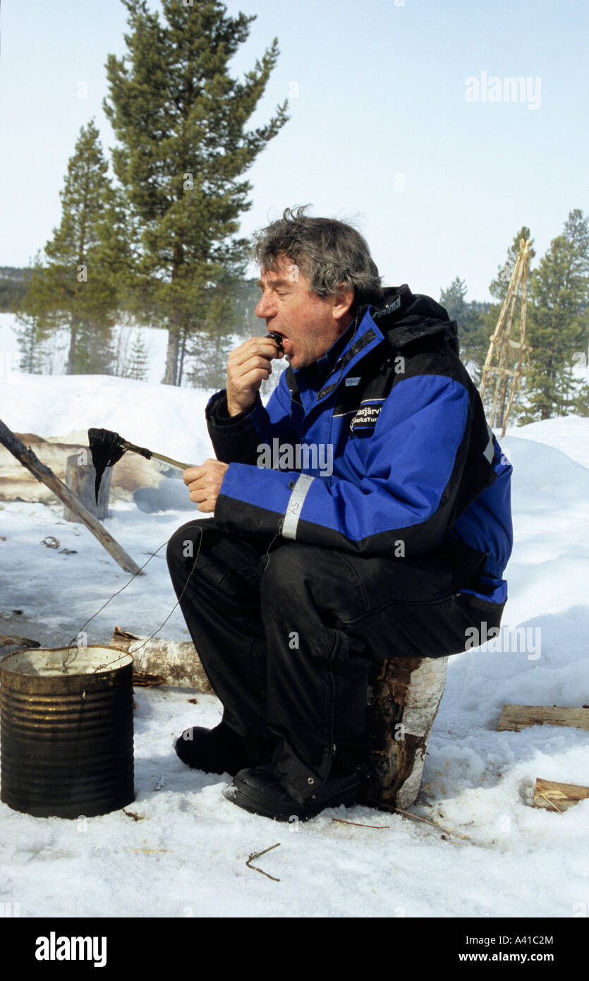 Survival course student gingerly tastes lichen soup in Swedish Lapland ...