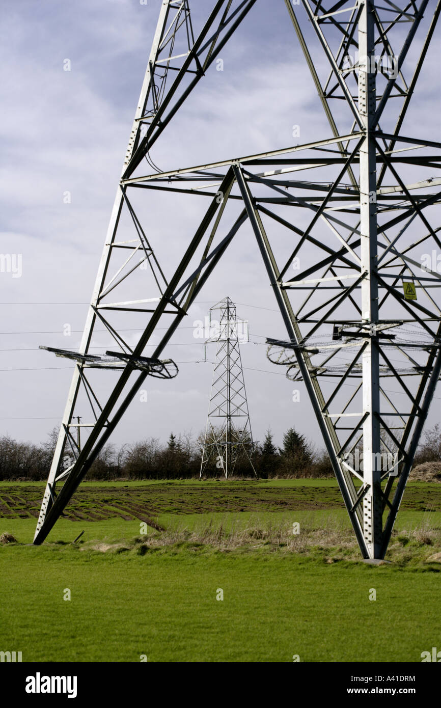 Two electricity pylons and transmission lines running across the ...