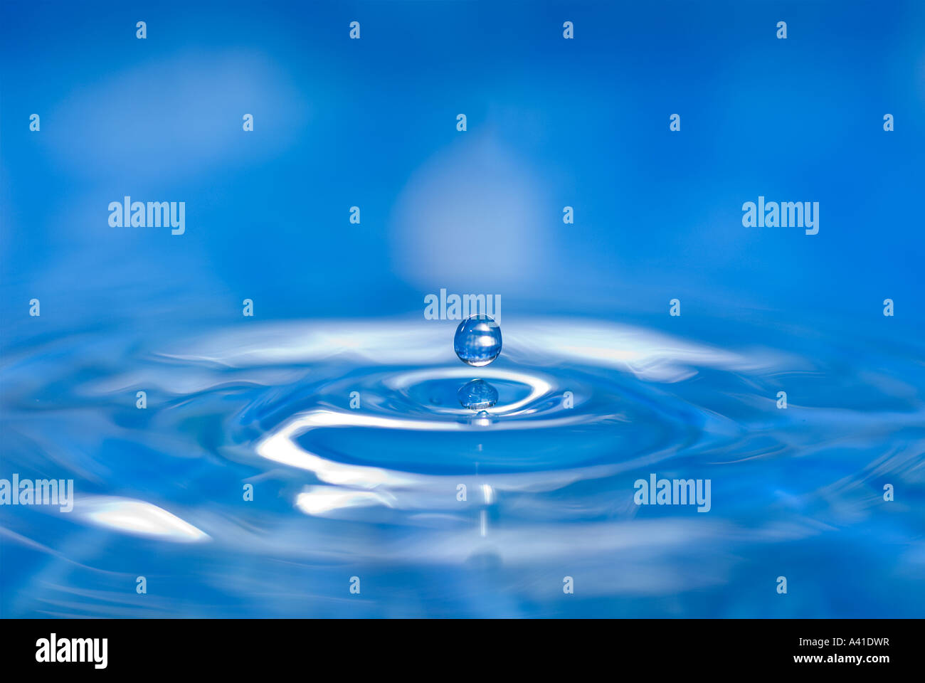 blue water and jumping waterdrop Stock Photo - Alamy