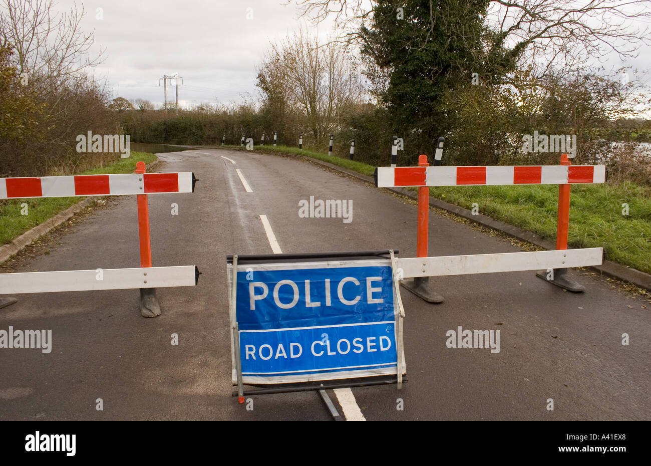 Police notice at country road flooded after heavy rain Stock Photo - Alamy