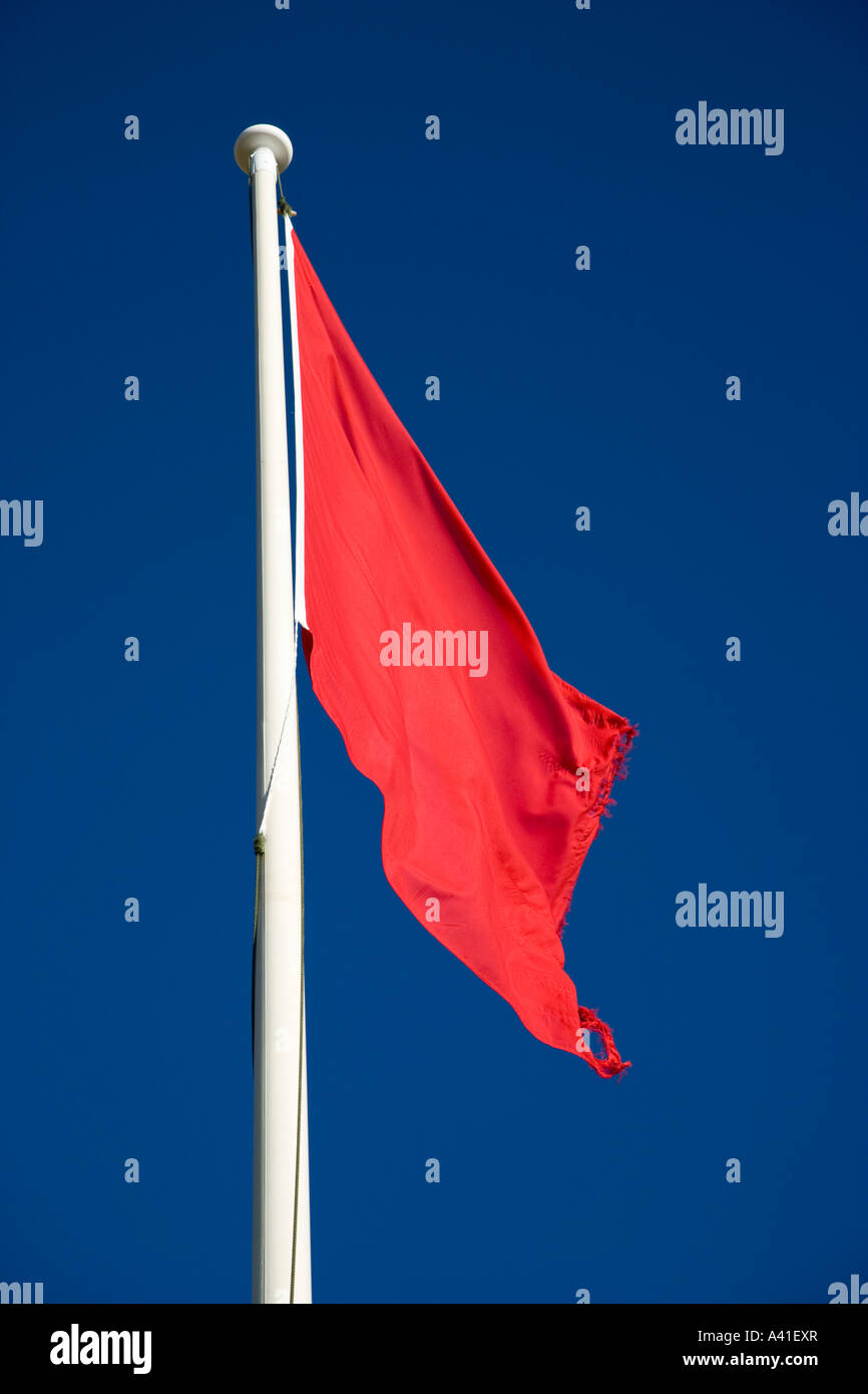 Danger flag against a blue sky Stock Photo - Alamy