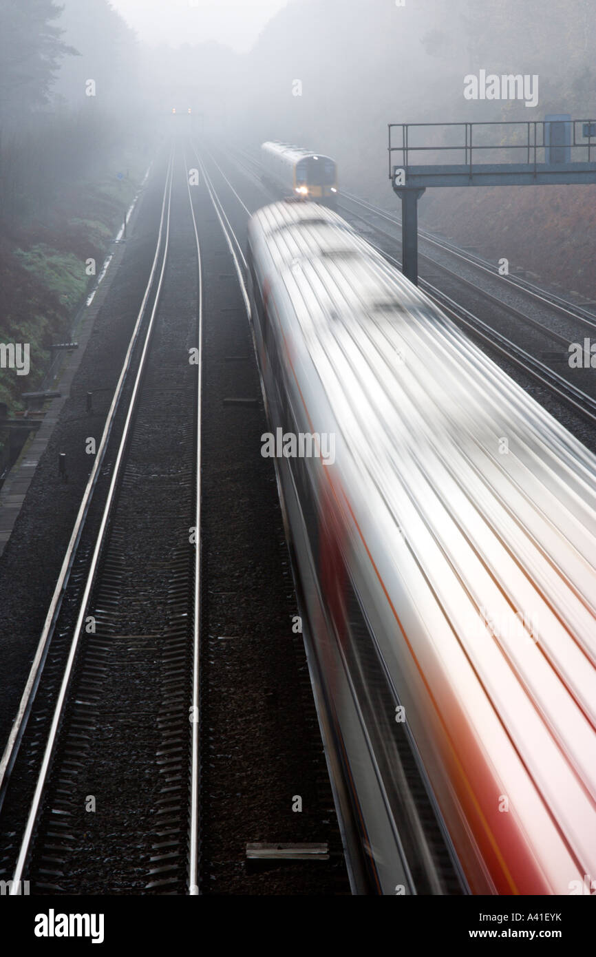 High speed trains passing in fog Stock Photo - Alamy