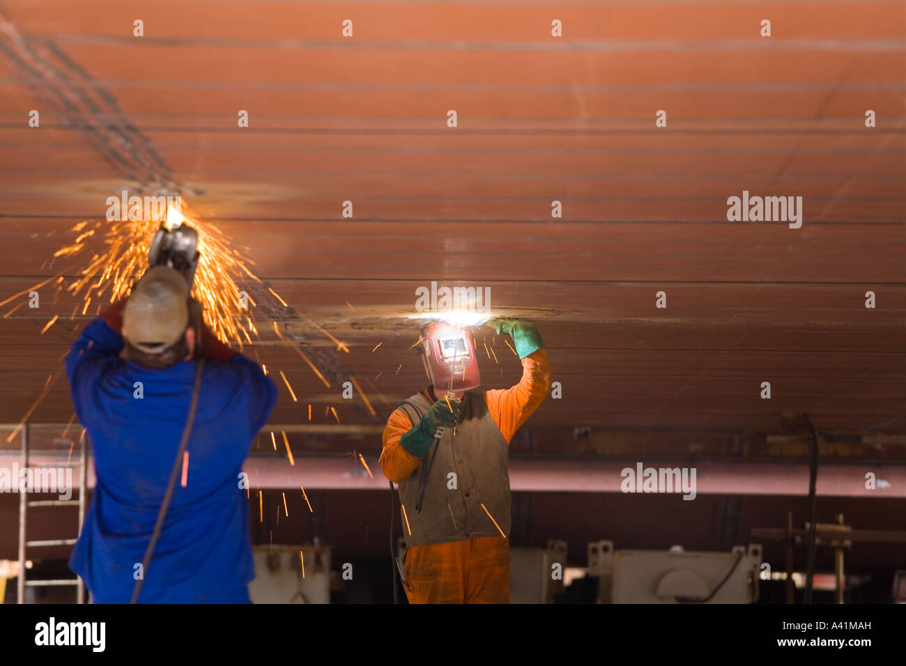 Welding under ship, two welders Stock Photo - Alamy