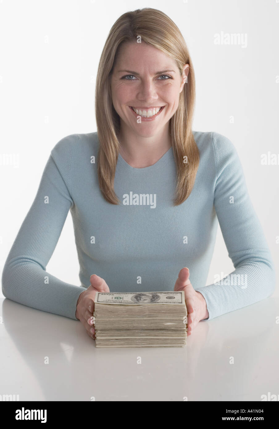 Woman with a stack of money Stock Photo - Alamy