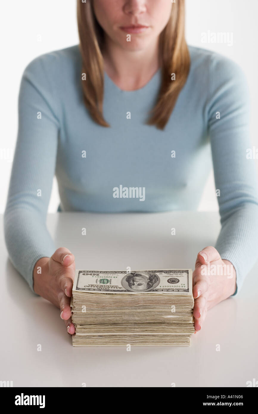 Woman with a stack of money Stock Photo - Alamy