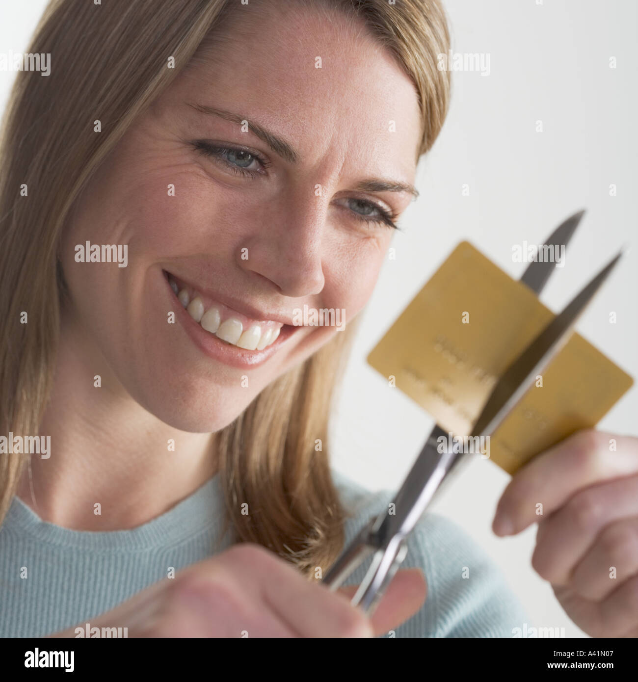 Woman cutting up credit card Stock Photo - Alamy