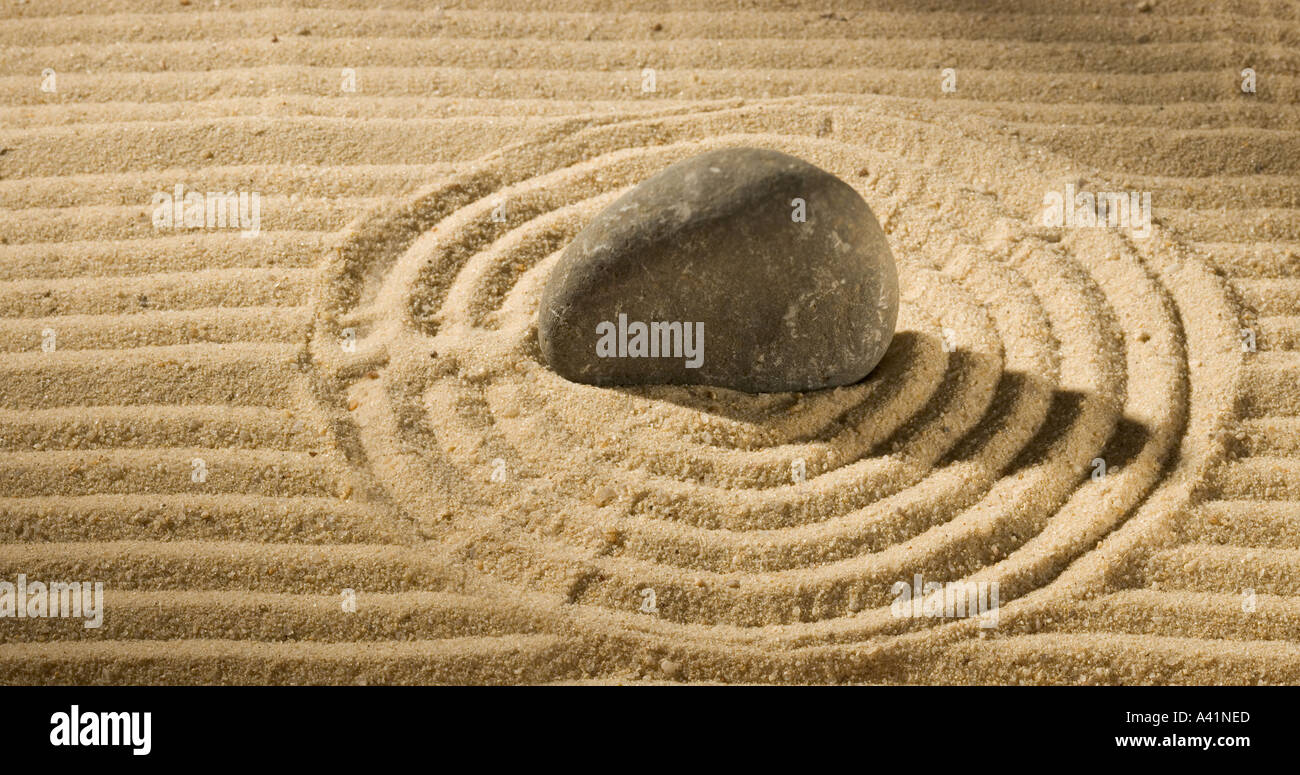 Still life of a stone on sand Stock Photo - Alamy