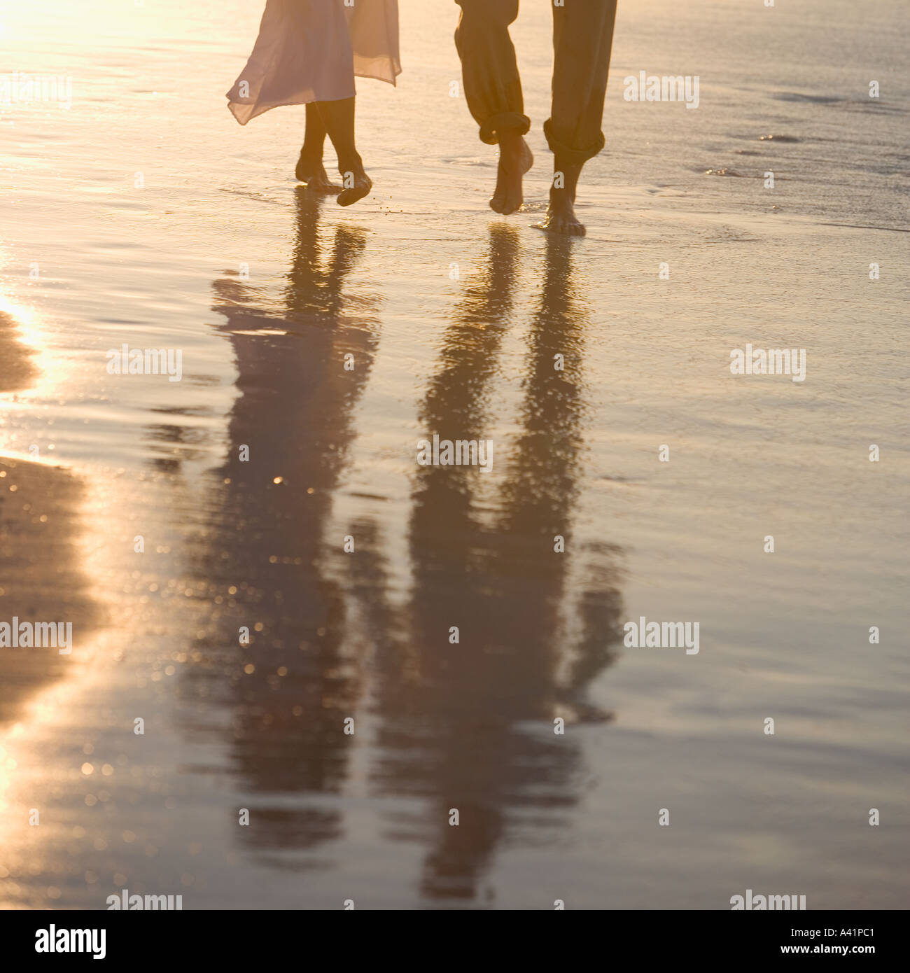 Couple strolling the beach Stock Photo - Alamy