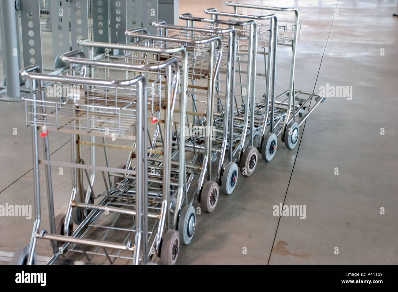 line up of caddies in airport Stock Photo - Alamy