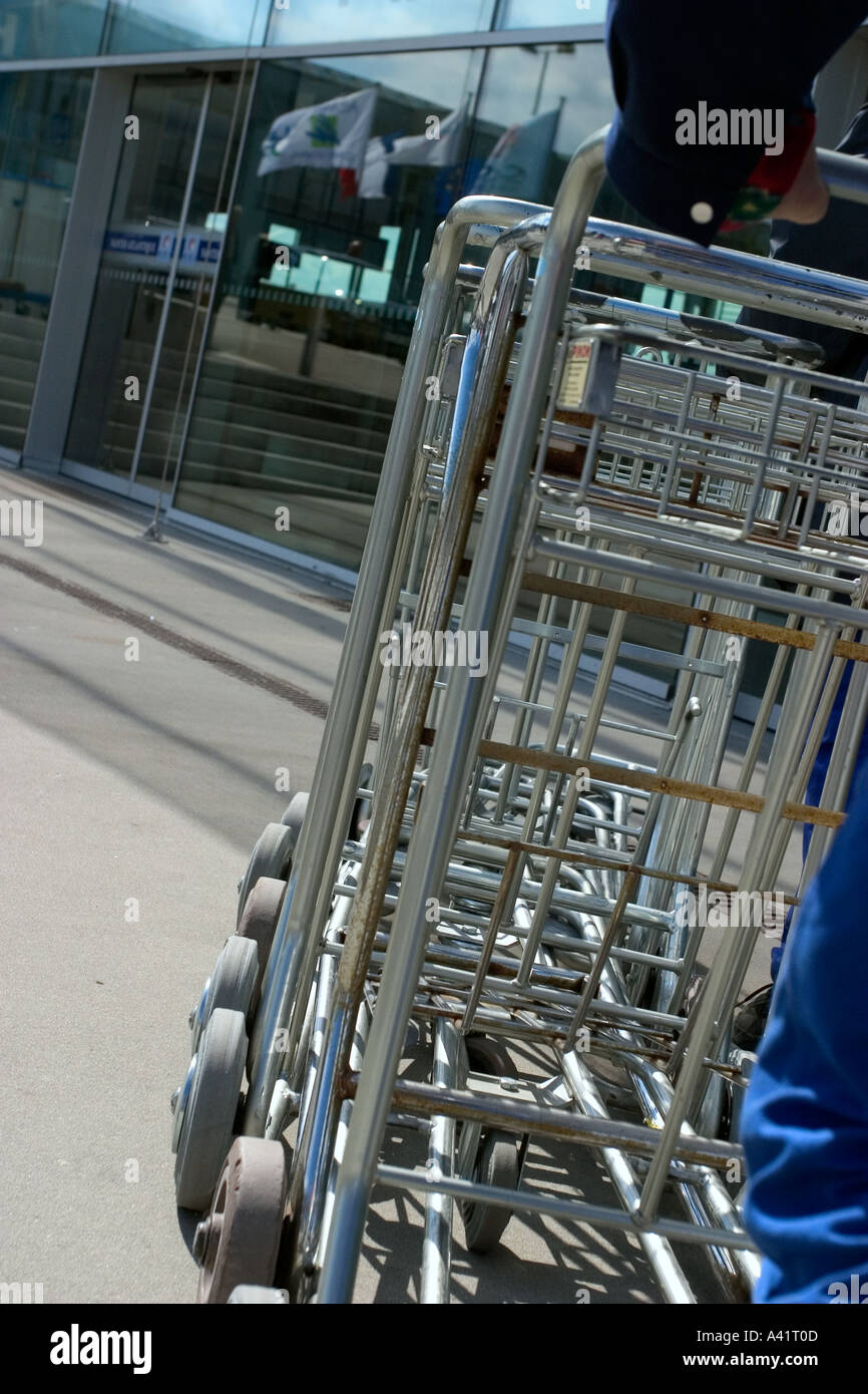 line up of caddies in airport Stock Photo - Alamy