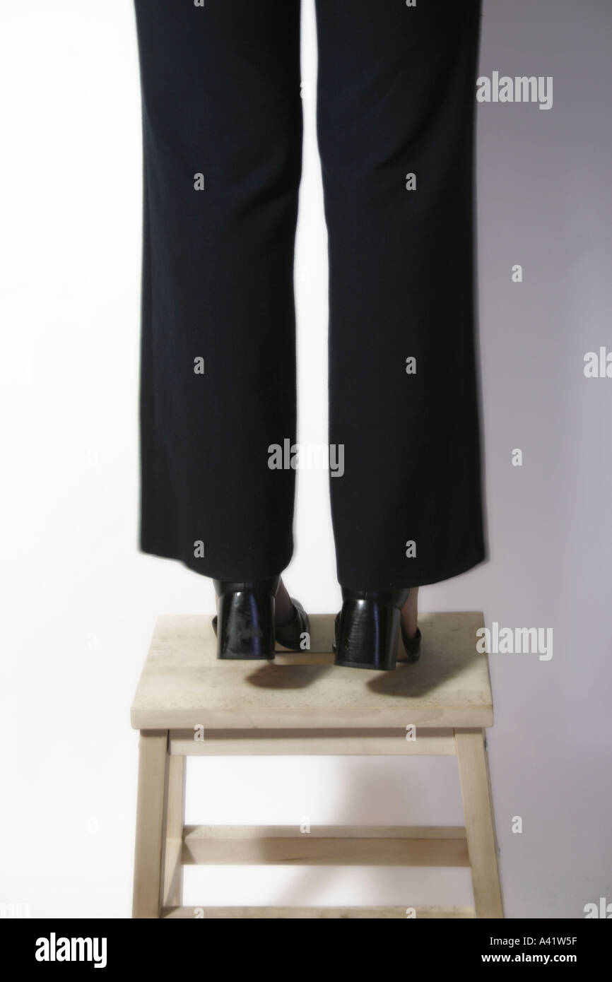 Legs only shot stood on stool reaching forward Stock Photo - Alamy