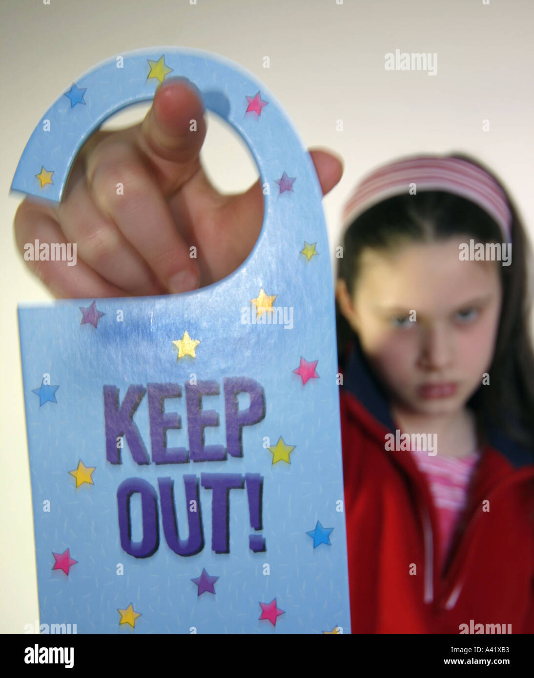 Young girl shows her keep out sign with unhappy face Stock Photo - Alamy