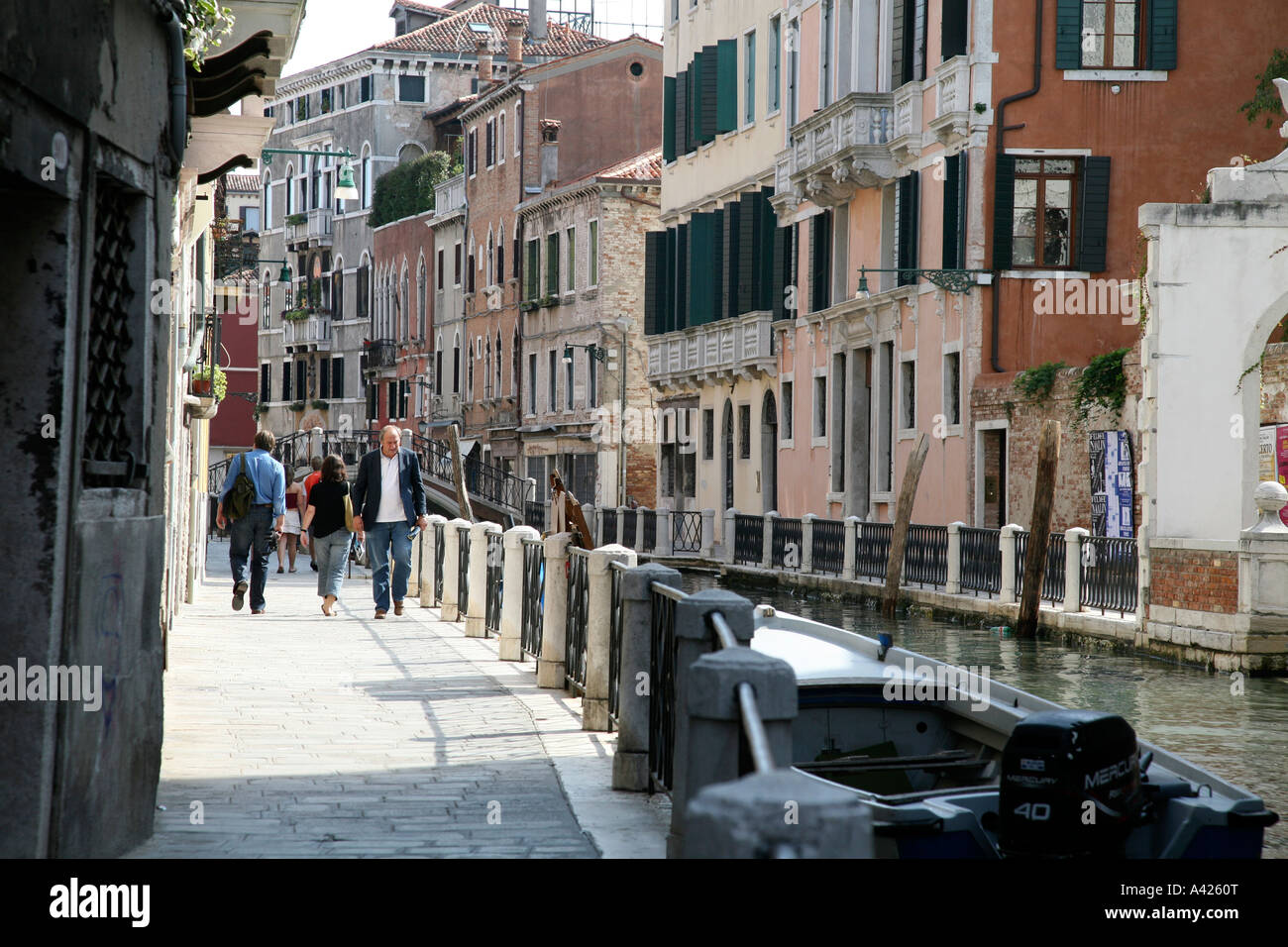 sidewalk along the canal in old Italy Venice Gondola on the Canal Stock ...