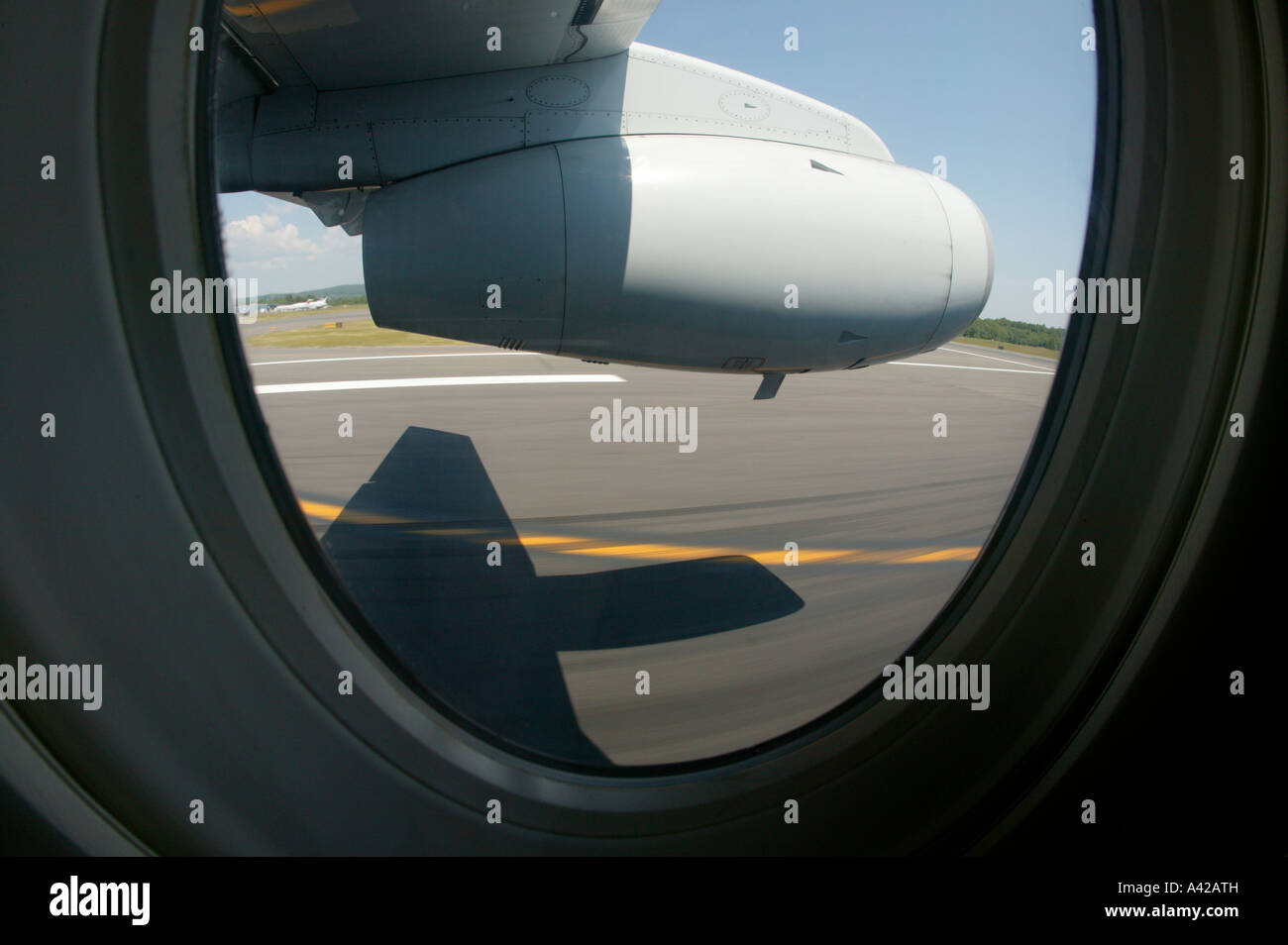Airplane window view of the airport runway and jet engine Stock Photo ...