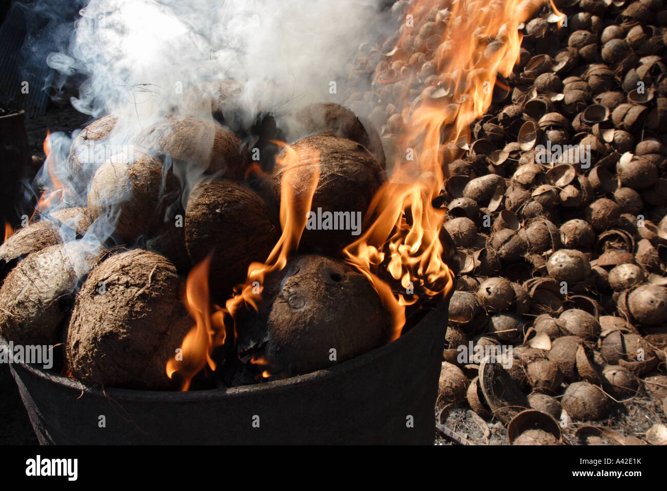 Coconut husks burning to make charcoal, Ko Samui, Thailand Stock Photo ...