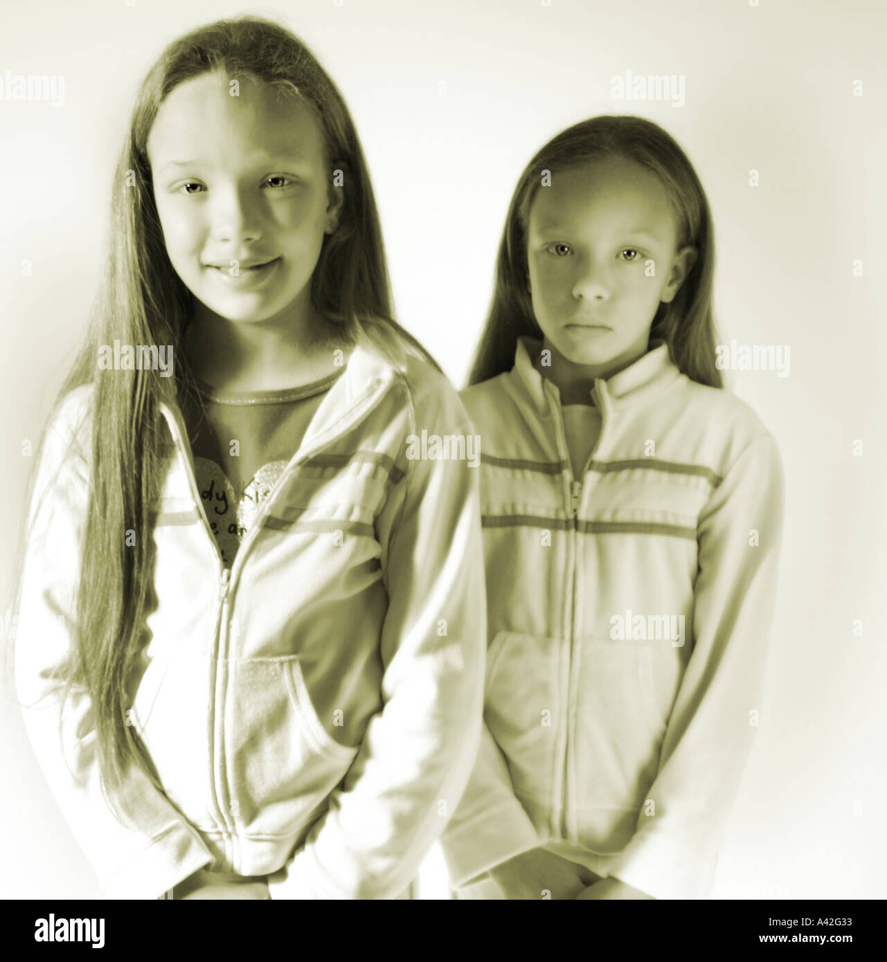 Twin sisters one happy the other sad age 10 Stock Photo - Alamy