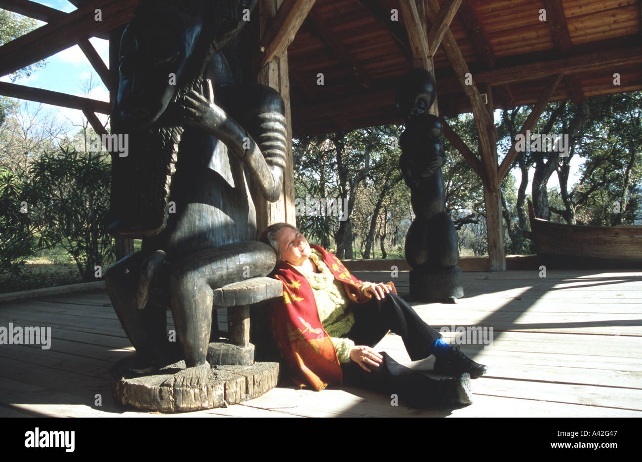 woman 50 55 years reclining leaning on Polynesian style statue Villa ...