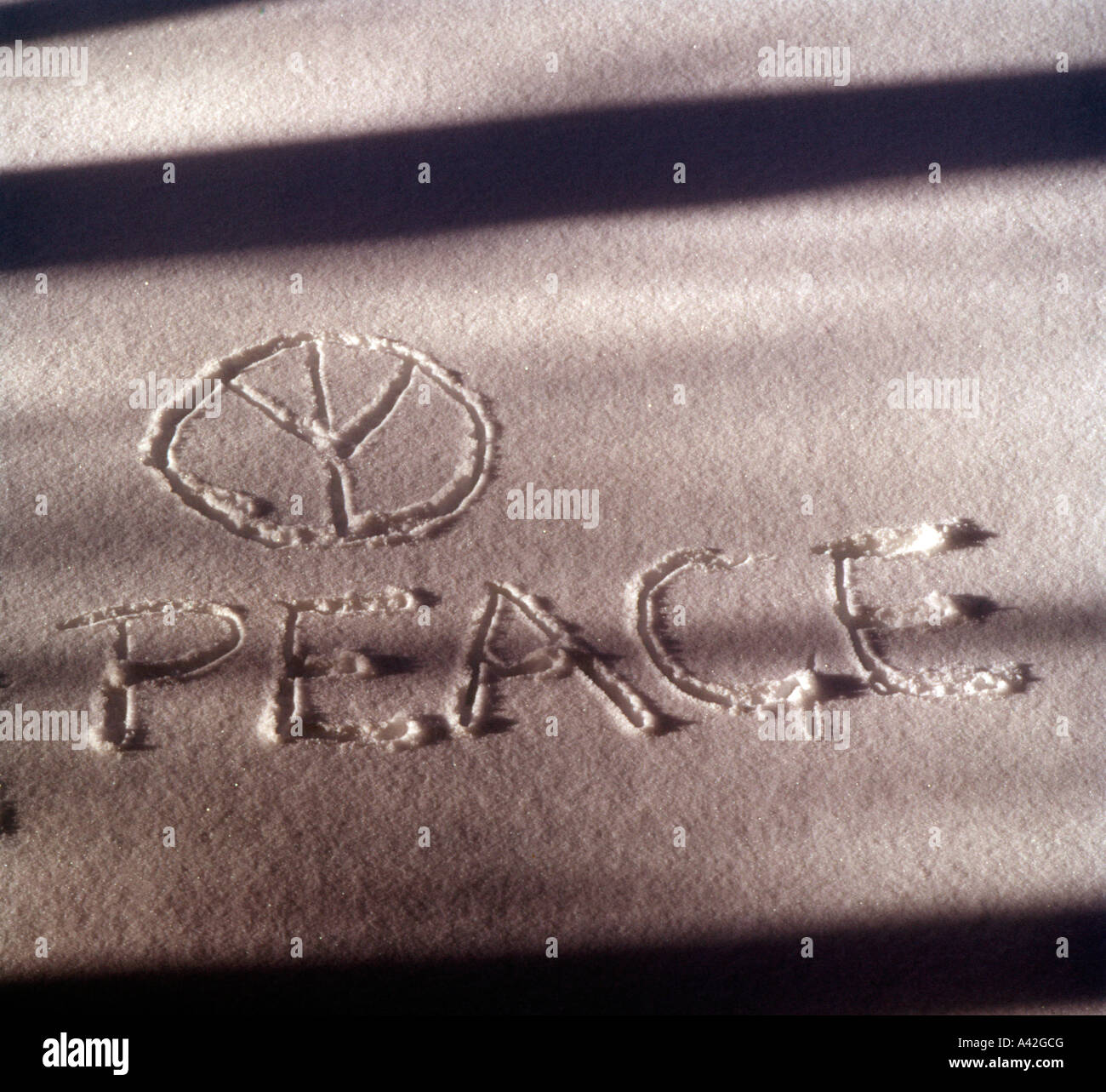 The Peace sign and the word Peace etched in newfallen snow on a late ...
