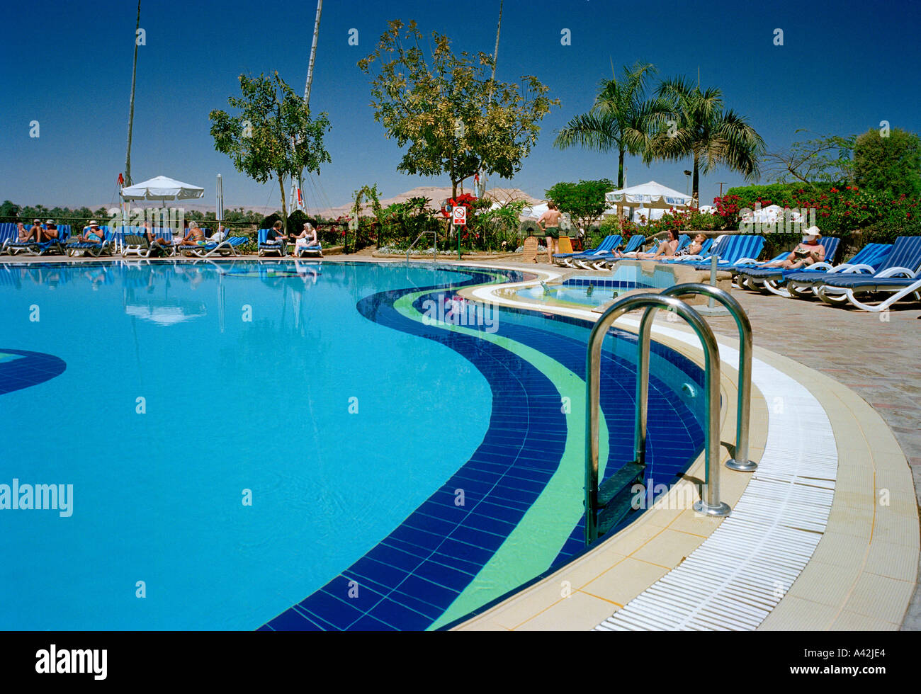 The swimming pool of a luxury hotel on the banks of the Nile at Luxor ...