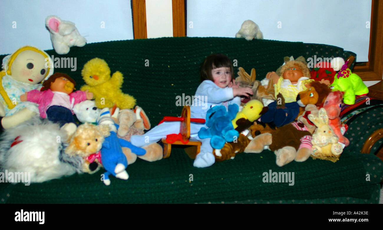 Little girl with her stuffed friends Stock Photo - Alamy