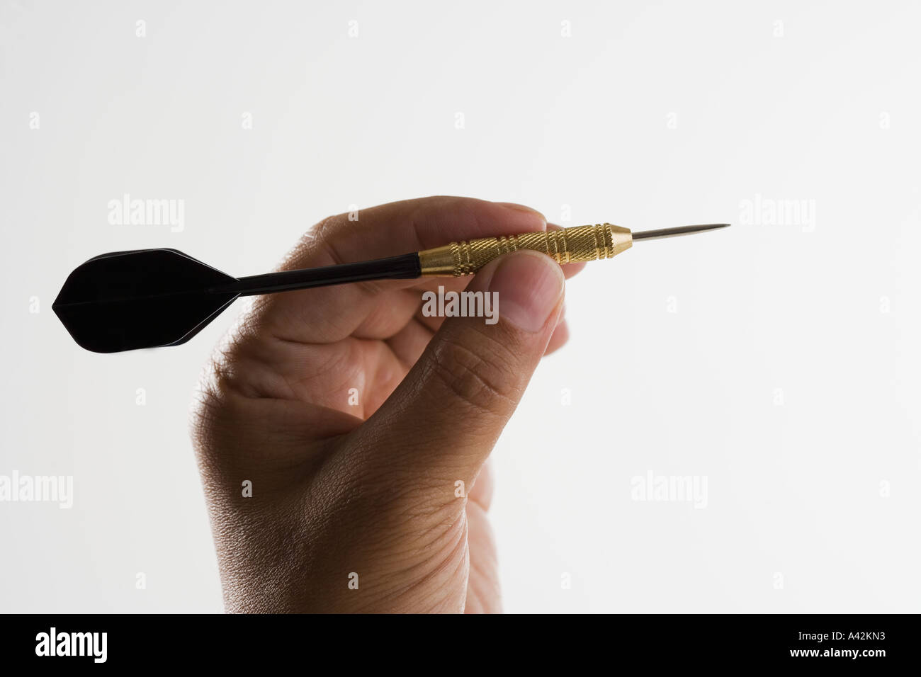 Close up of hand holding dart Stock Photo - Alamy