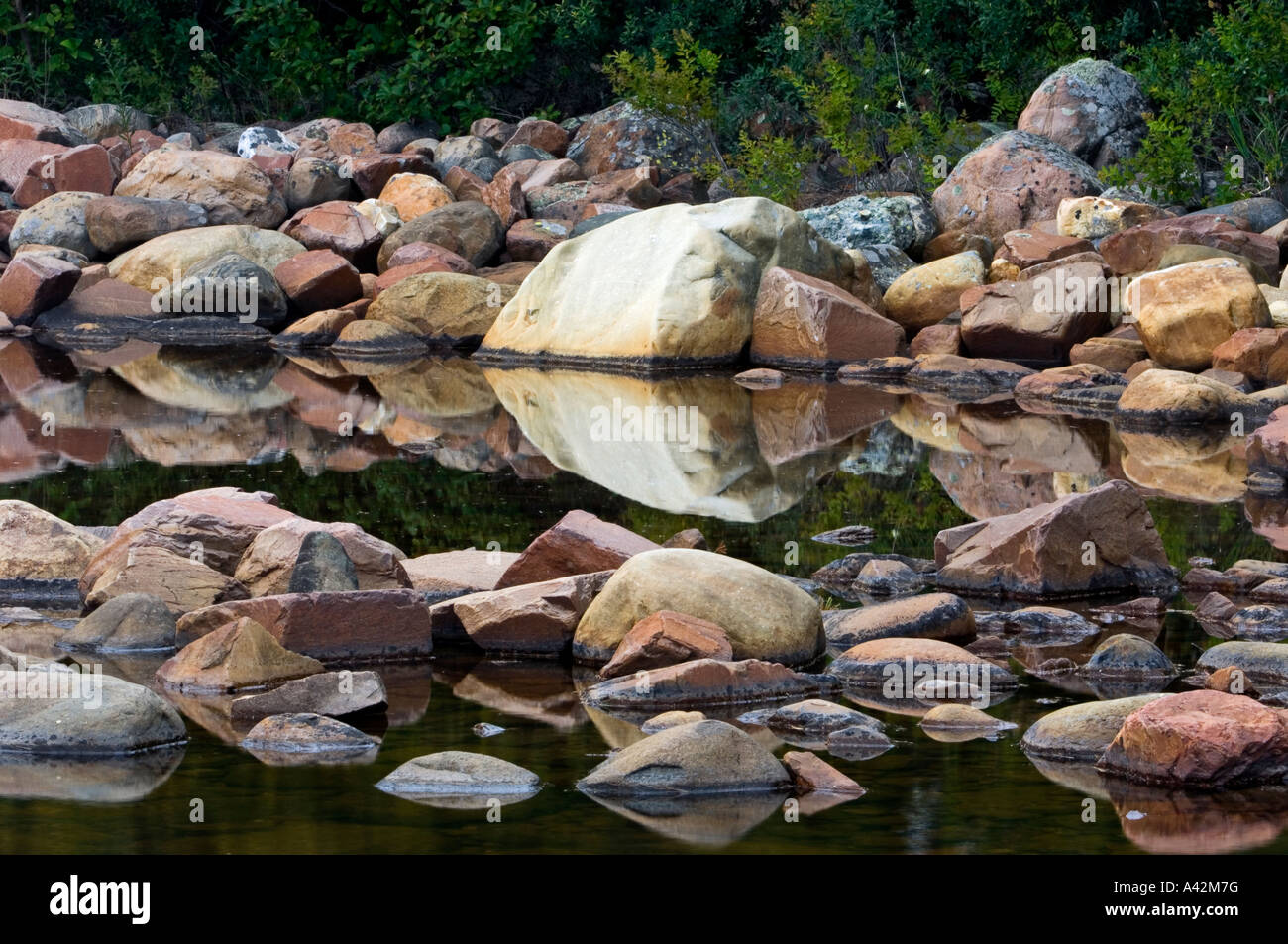 Weathered boulders and pool along Lake Huron shore, Killarney, Ontario ...