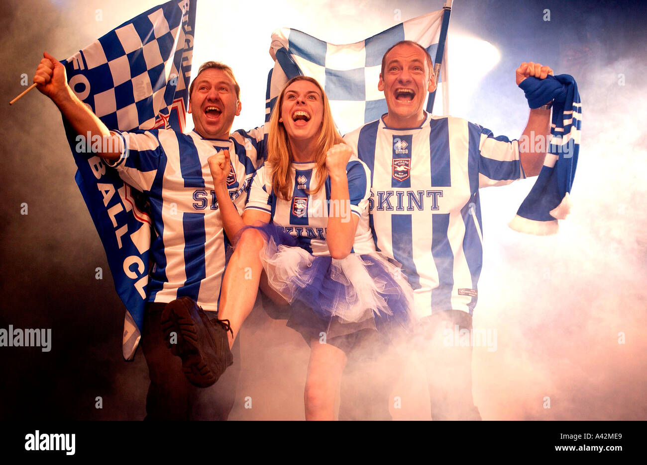 Cheering football fans in blue and white Stock Photo - Alamy