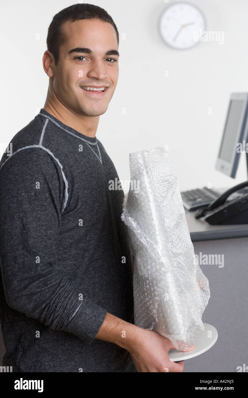 Portrait of man holding object in office Stock Photo - Alamy