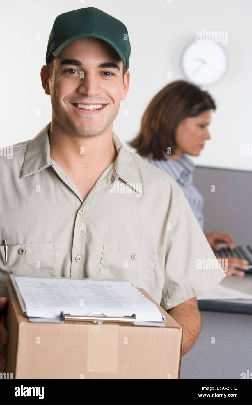 Portrait of delivery man with box Stock Photo - Alamy