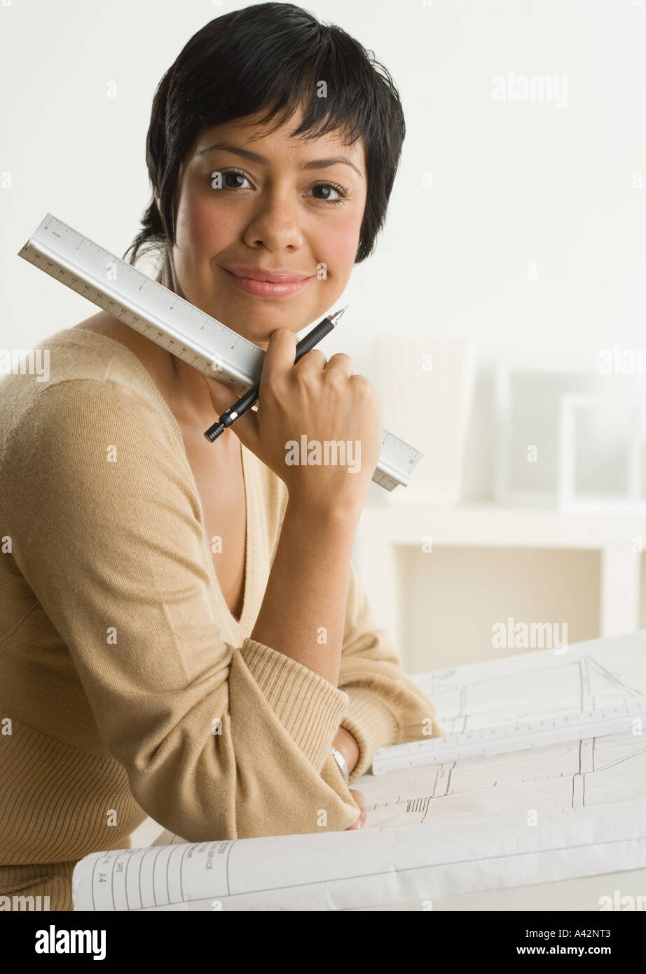 Portrait of woman with ruler and plans Stock Photo - Alamy